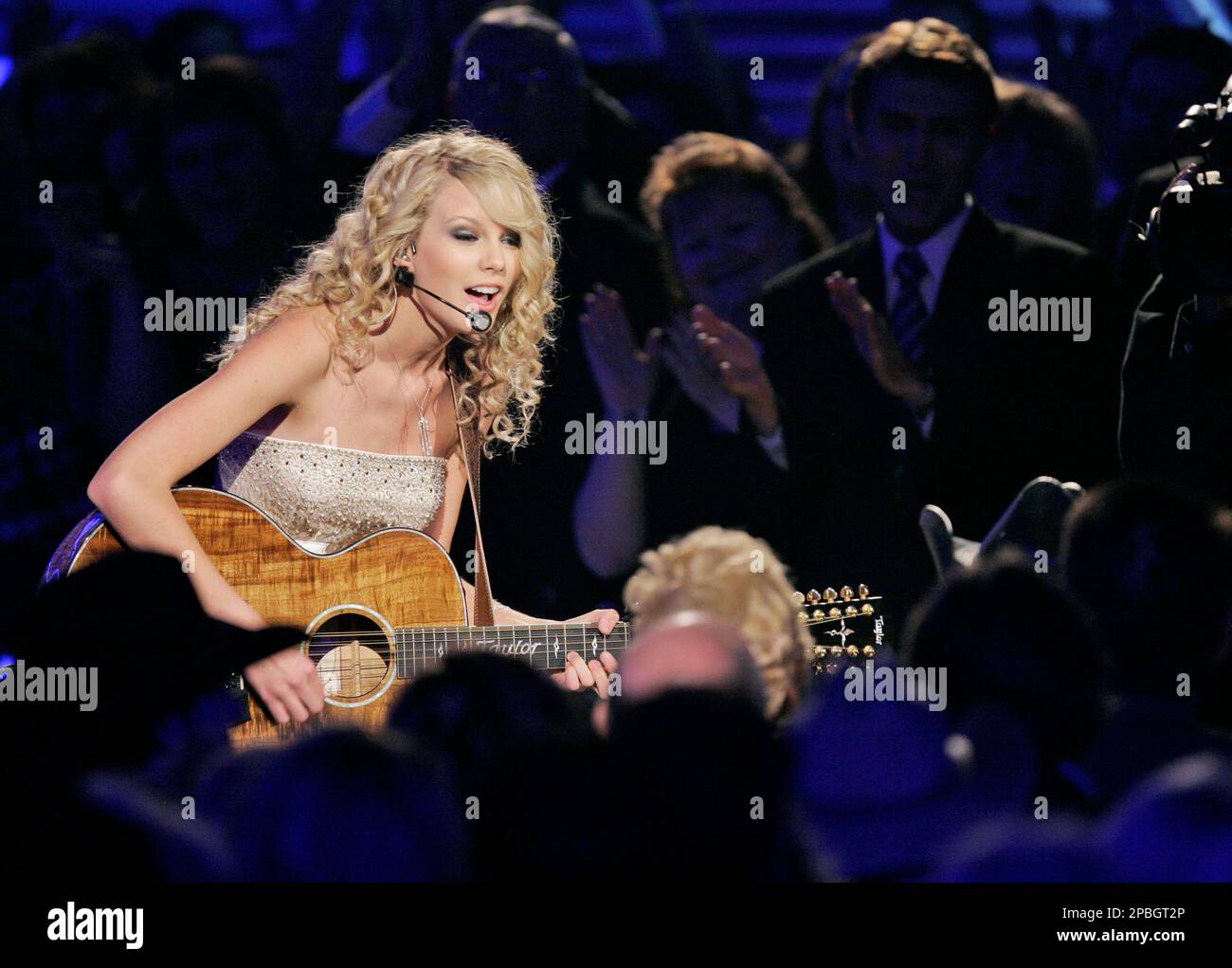 Taylor Swift performs her song "Tim McGraw" to the country star sitting ...