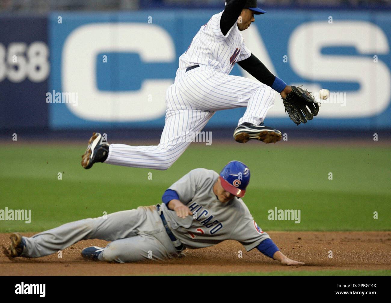 Chicago Cubs' Ryan Theriot steals second beneath a leaping New York ...