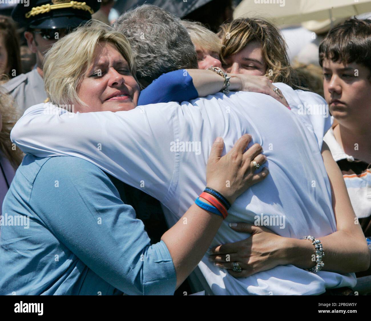 President Bush, back to camera, comforts Amy Sumner, widow of Chelsea, Mich., Police Chief R ...