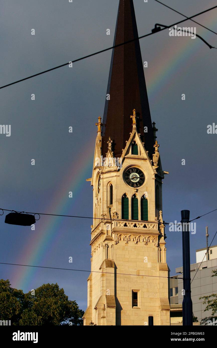 A rainbow rises behind the St. Peter and Paul church in Zurich ...