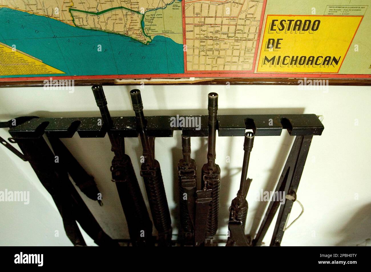 Guns placed next to a Michoacan state map are seen at the Attorney ...