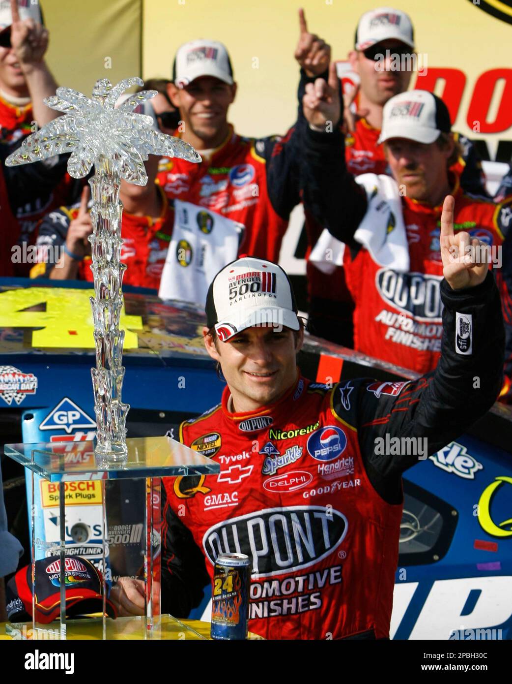 Jeff Gordon poses with the trophy in victory lane after winning the NASCAR Nextel Cup Dodge ...