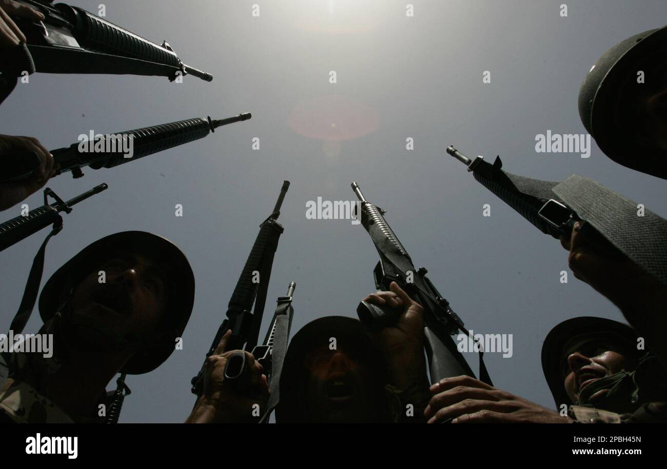 Iraqi soldiers hold their new rifles, provided by U.S. forces, in Taji ...