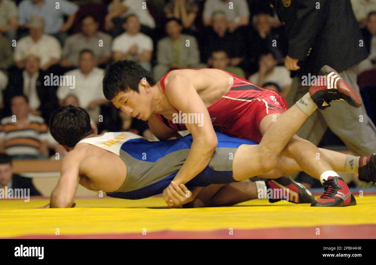 South Korea's Moon Ho-seon, top, and Iran's Hamid Bavafa wrestle during the 60-kilogram men's ...