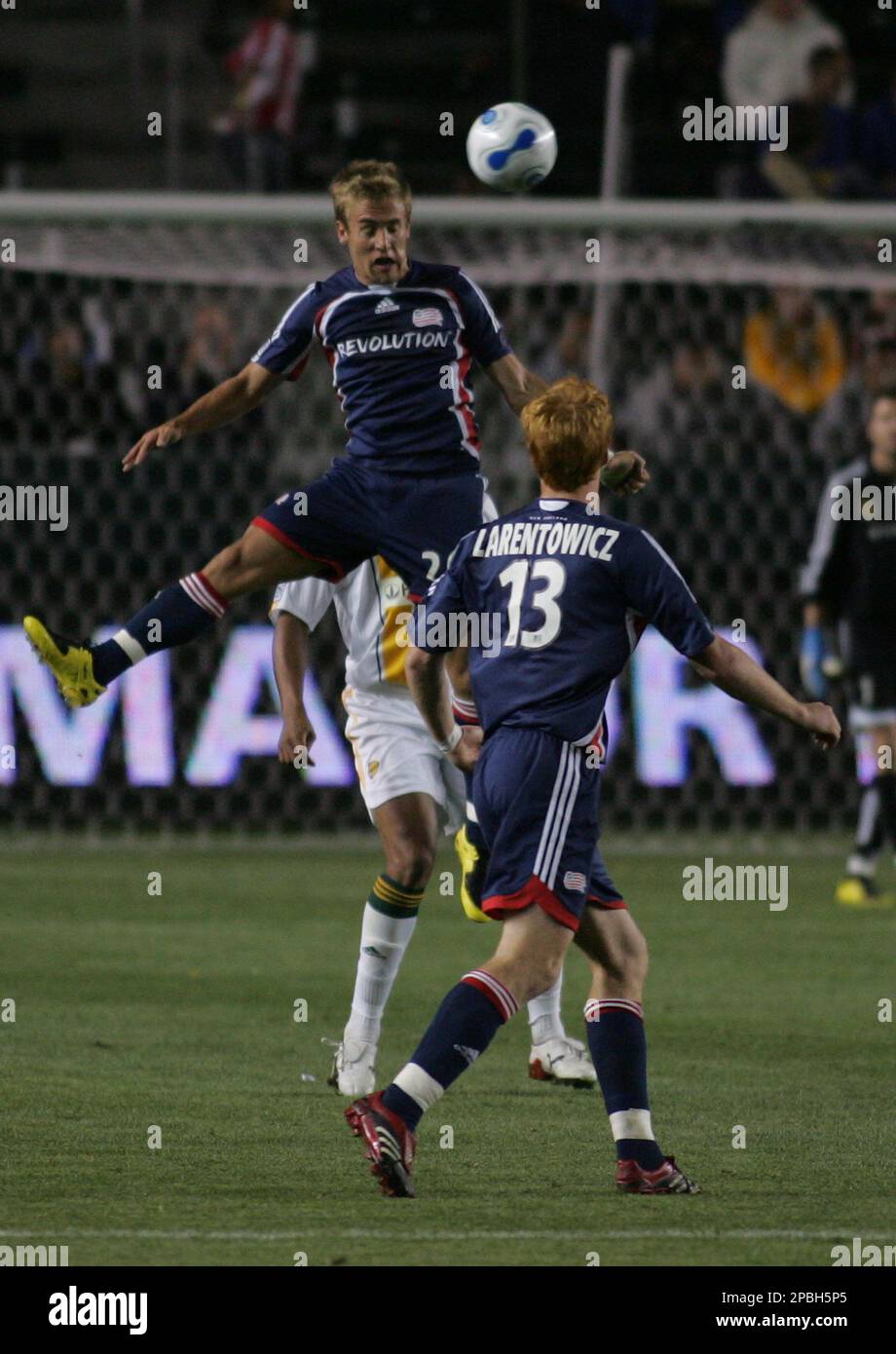 New England Revolution's Taylor Twellman, top, heads the ball against ...