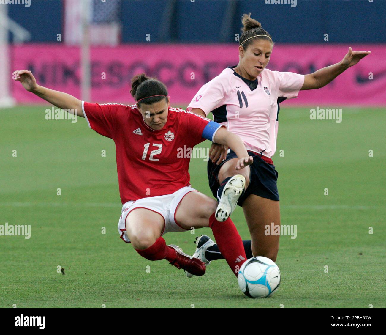 Canada's Christine Sinclair (12) and U.S.' Carli Lloyd (11) compete for ...