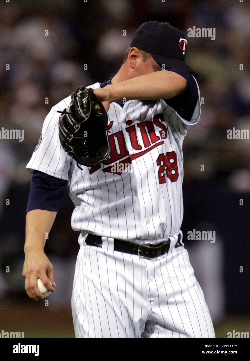 Minnesota Twins pitcher Jesse Crain wipes his face after loading the ...
