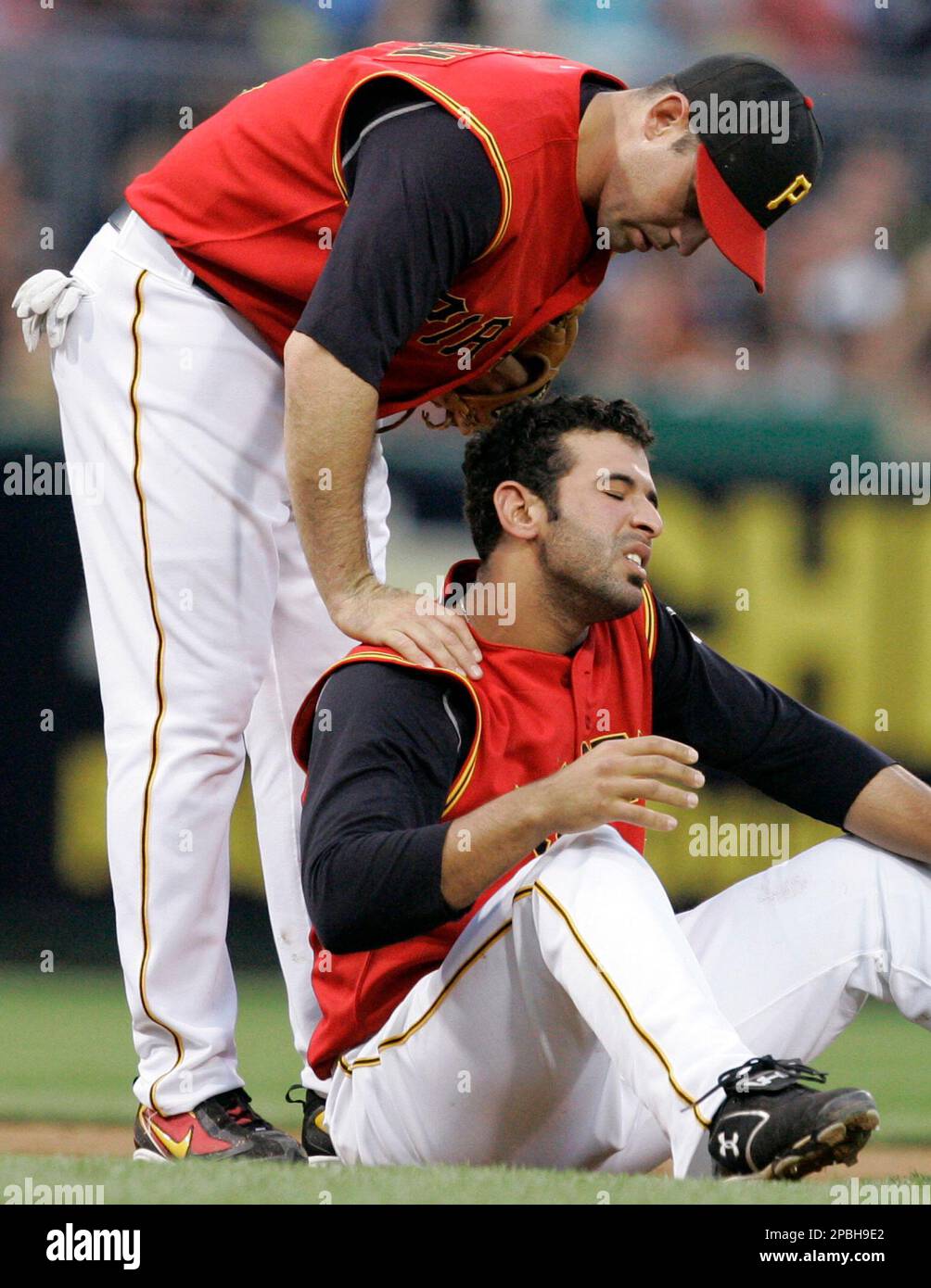Pittsburgh Pirates third baseman Jose Bautista, right, is checked by ...