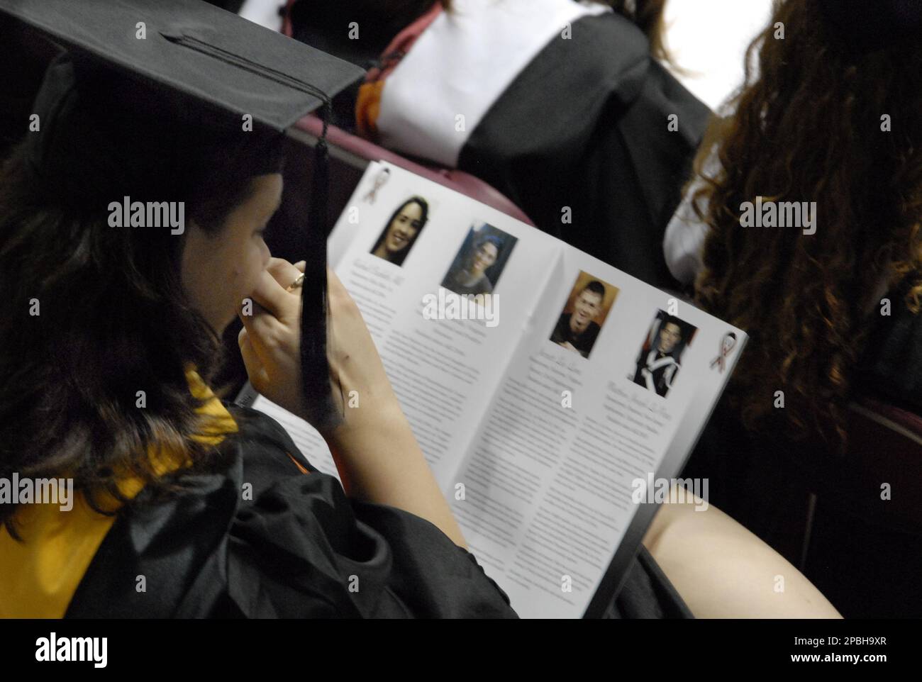A Virginia Tech graduate student wipes away tears as she reads the ...