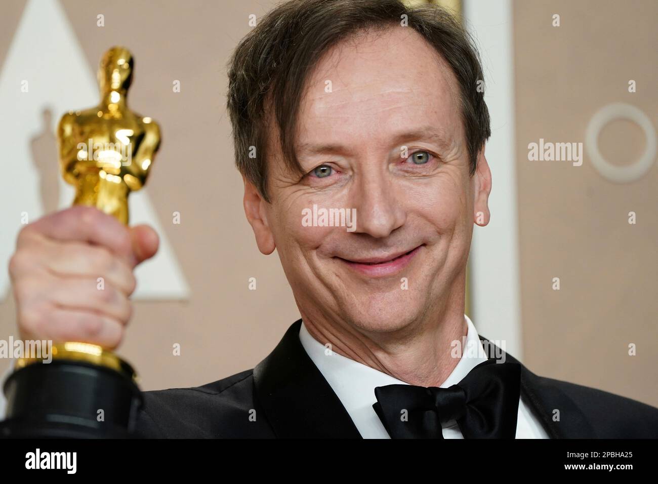 Volker Bertelmann poses with the award for best original score for "All ...