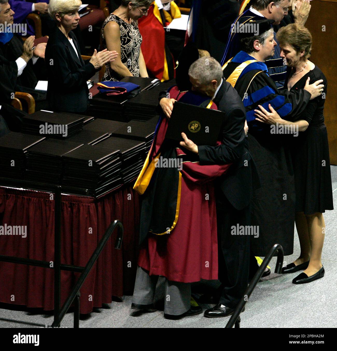 Karen and Harry Pryde are embraced by Virginia Tech faculty members as ...