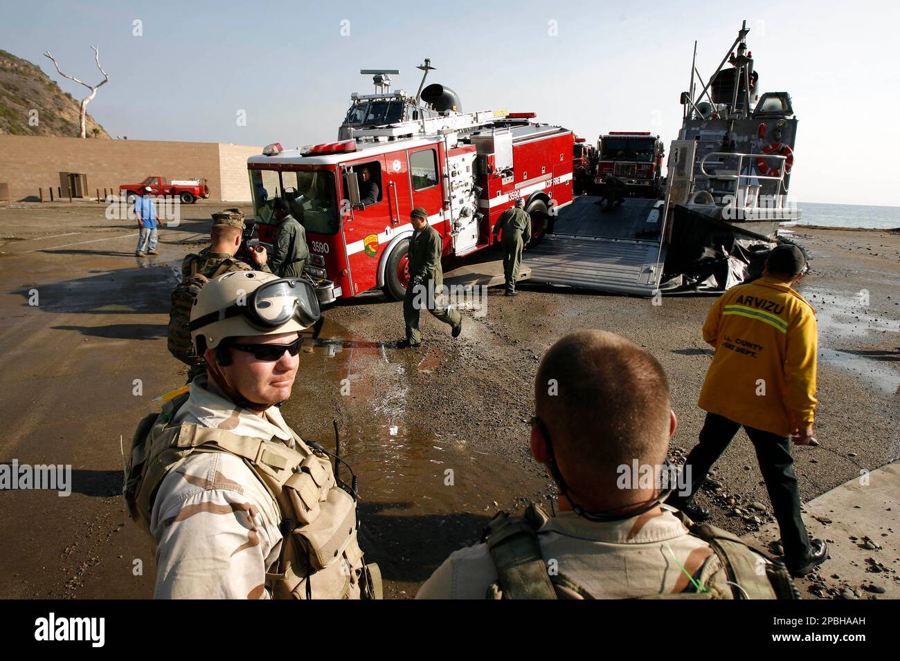 A California Department of Forestry fire truck is unloaded from a Navy ...