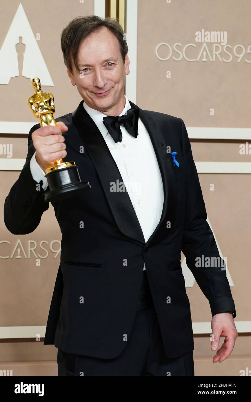 Volker Bertelmann poses with the award for best original score for "All ...