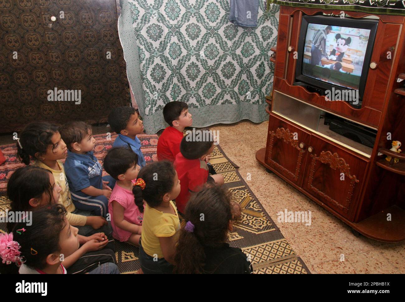 Palestinian children watch Al-Aqsa TV, a station run by Hamas, during a ...
