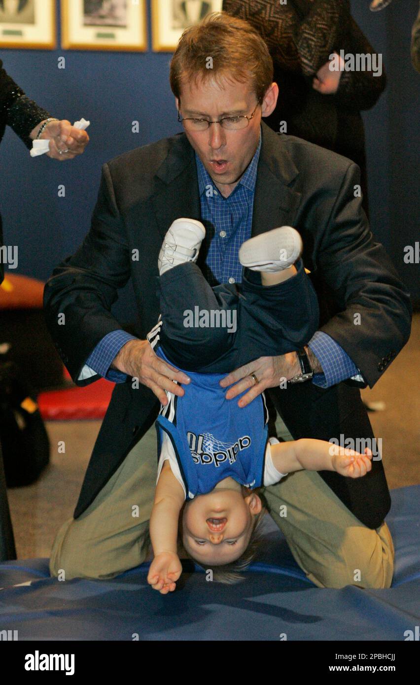 Former Olympic golf medalist Bart Conner helps his 11-month old son ...