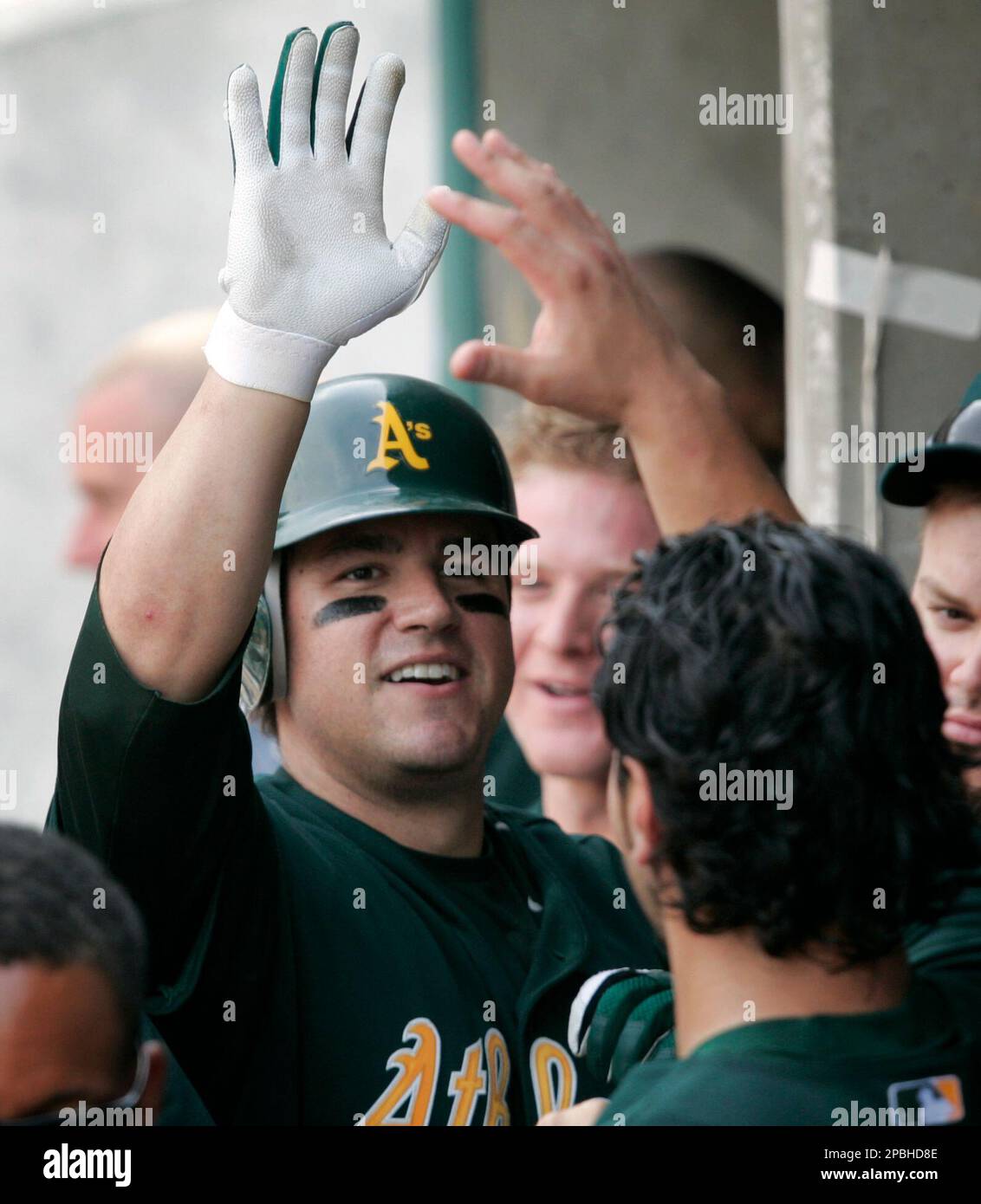 Oakland Athletics' Jack Cust, left, is congratulated by Eric Chavez ...