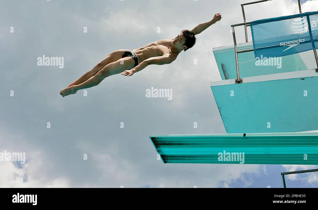 Luo Yutong, from China, makes a dive in the Men's 3m Springboard ...