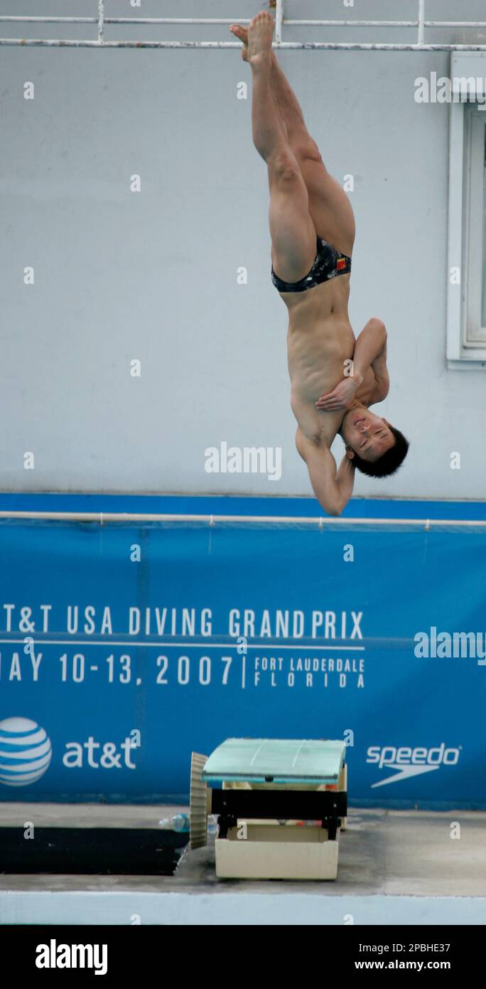 Luo Yutong, from China, makes a dive in the Men's 3m Springboard ...