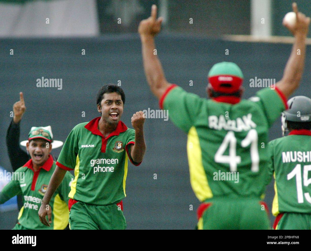 Bangladeshi cricketer Syed Rasel, second left, reacts after taking the ...
