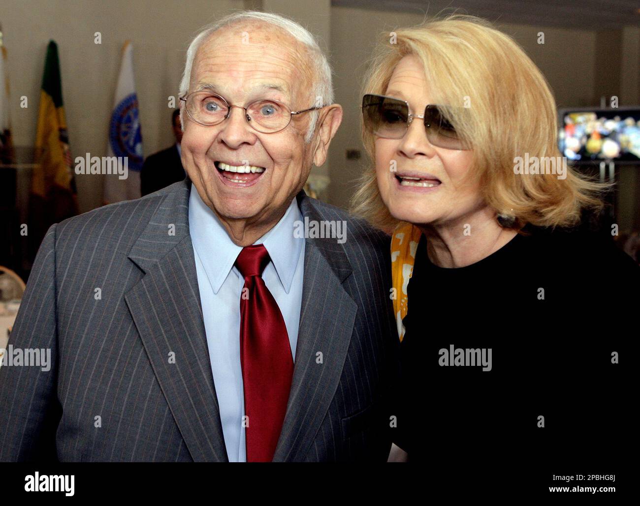 Hollywood's honorary mayor, Johnny Grant, left poses for a photo with ...