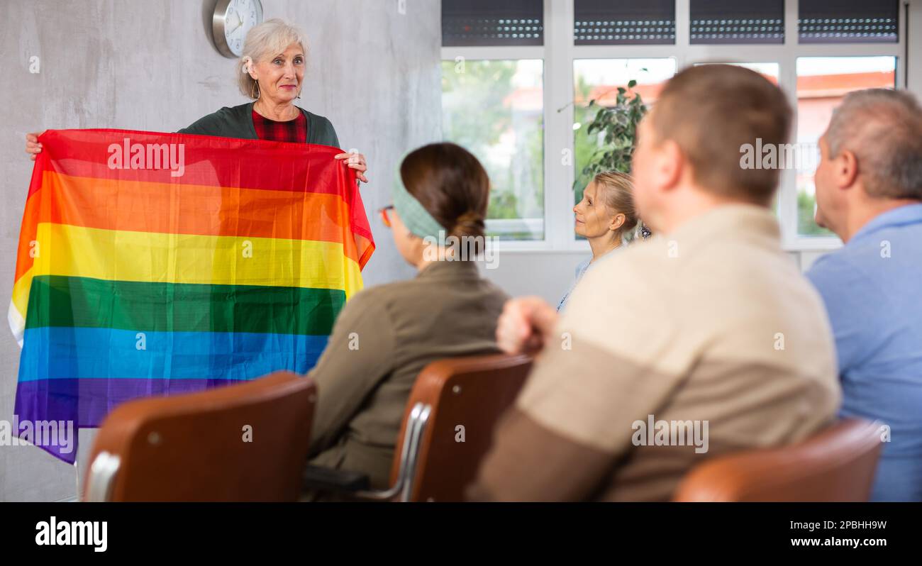 Focused adult students sitting at lesson with classmates, listening ...