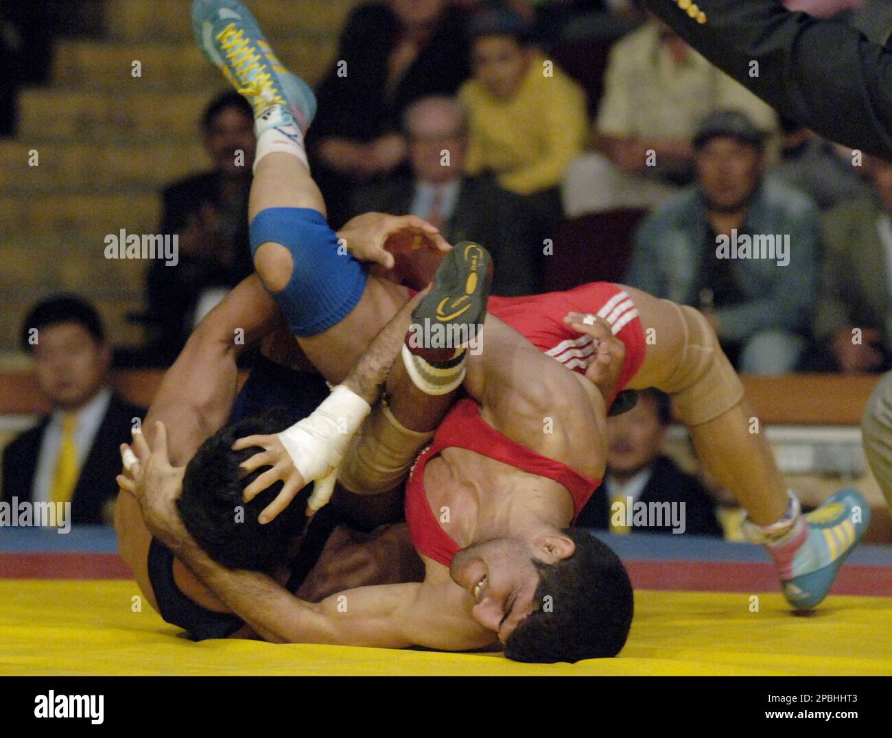 Iran's Hassan Tahmasi, right, and India's Sushil Kumar wrestle in the ...