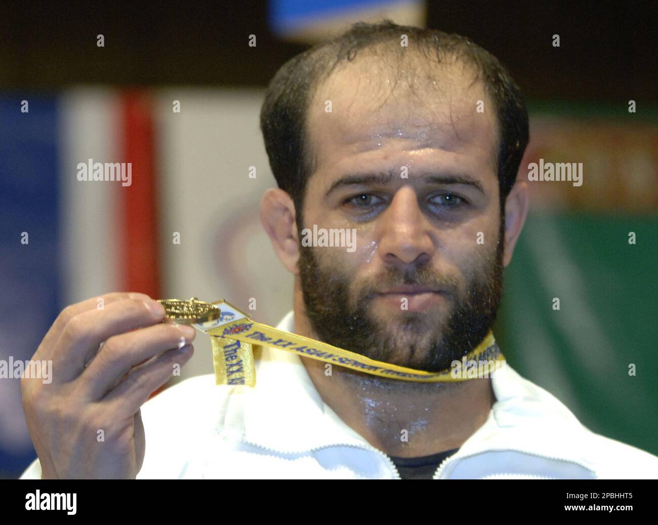 Iran's Fardin Masoumi Valadi shows his gold medal won in the 120 ...