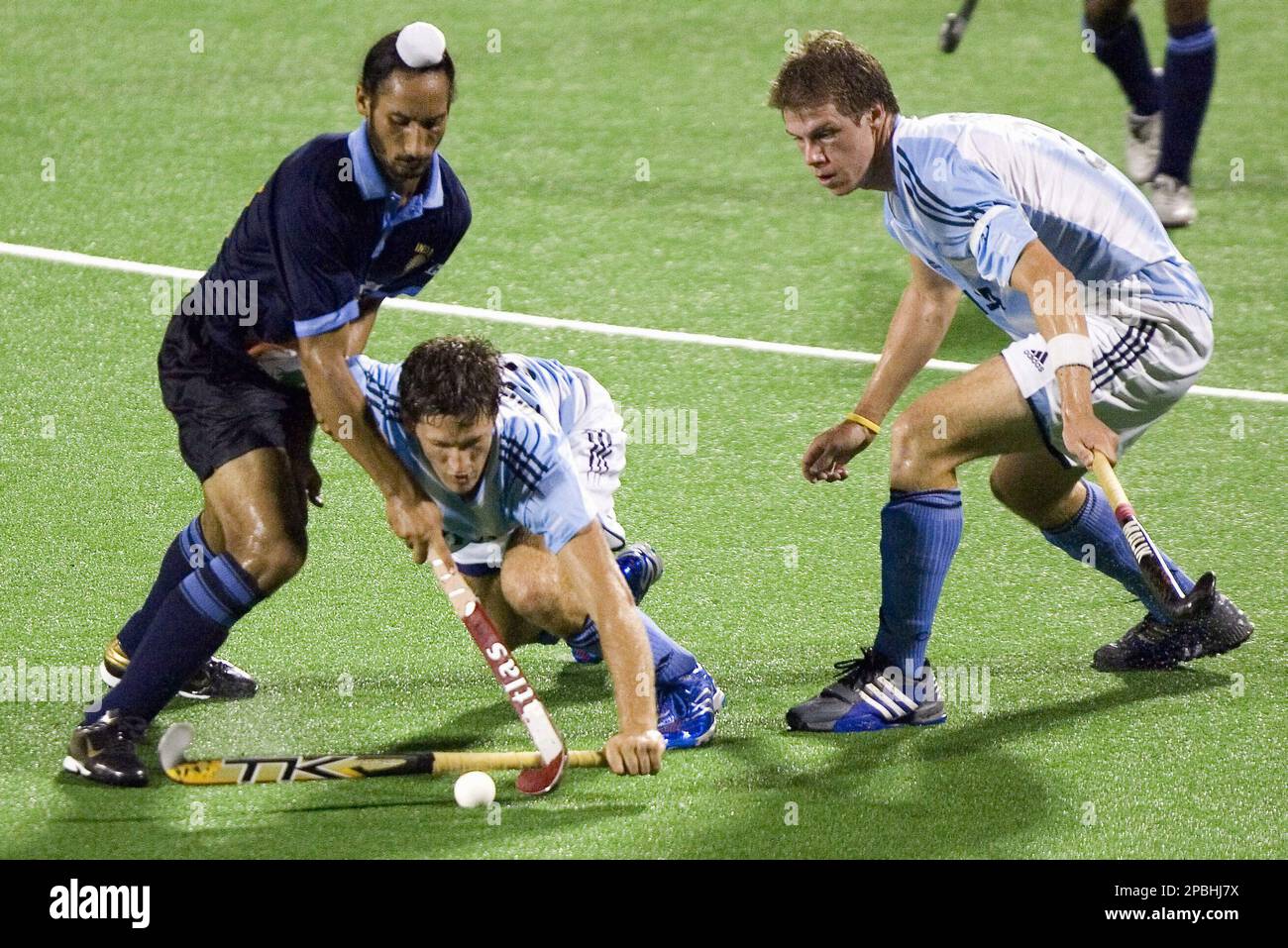 India's Sardar Singh, left, is challenged by Argentina's Argento Lucas ...
