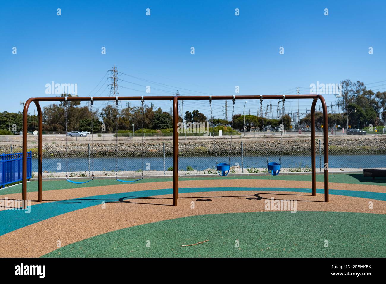 Metal four seat swings outdoors. Childrens swings on playground. Swings ...