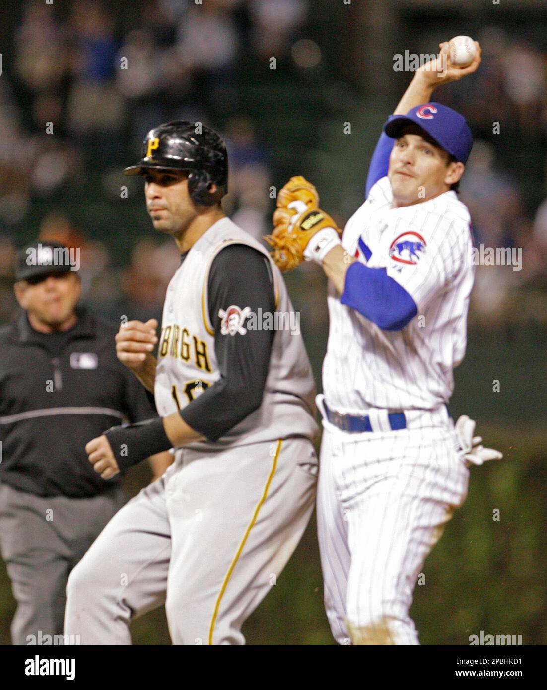 Chicago Cubs' Ryan Theriot throws to first to complete a double play ...