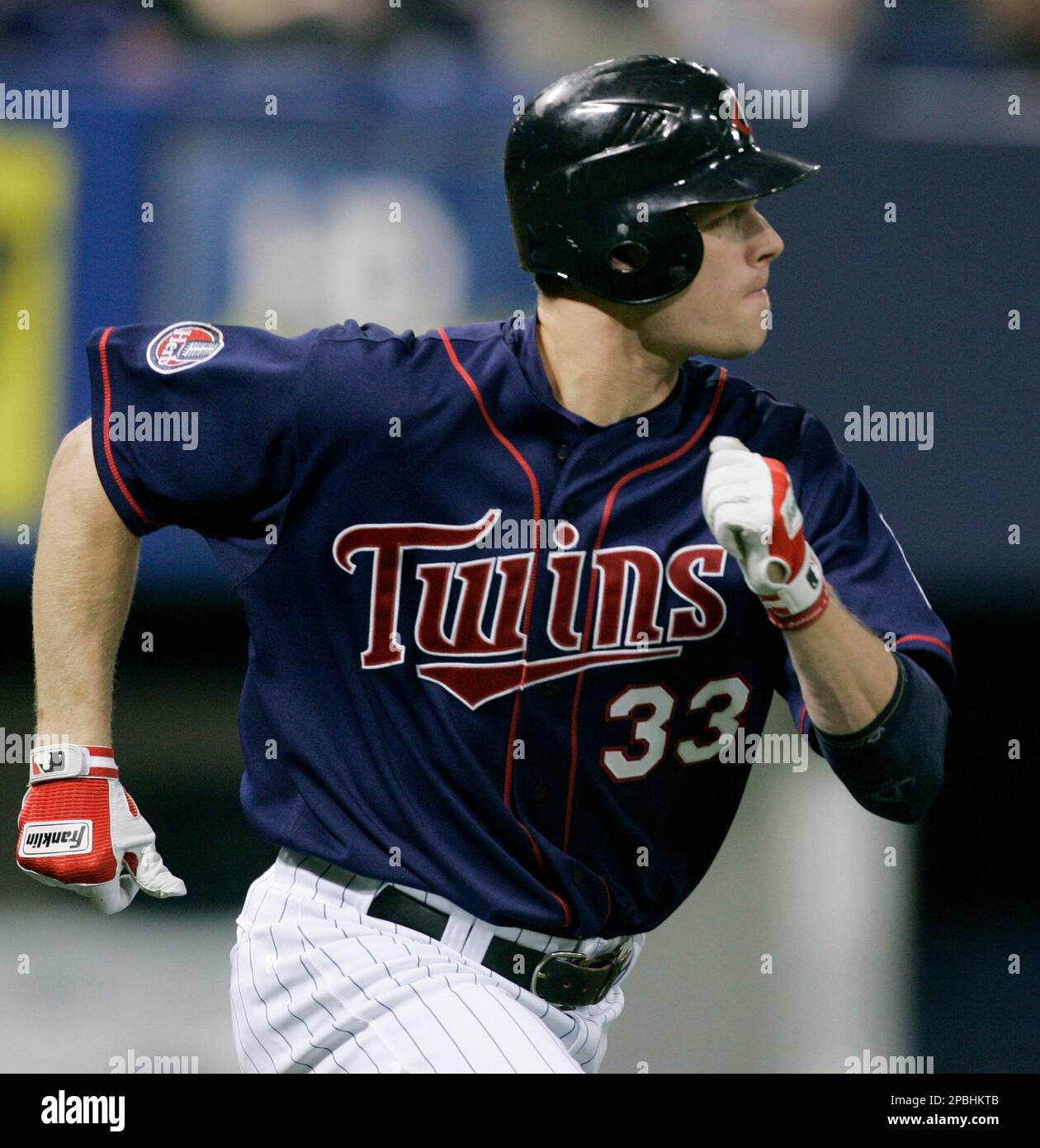 Minnesota Twins' Justin Morneau races to first as he watches his solo ...