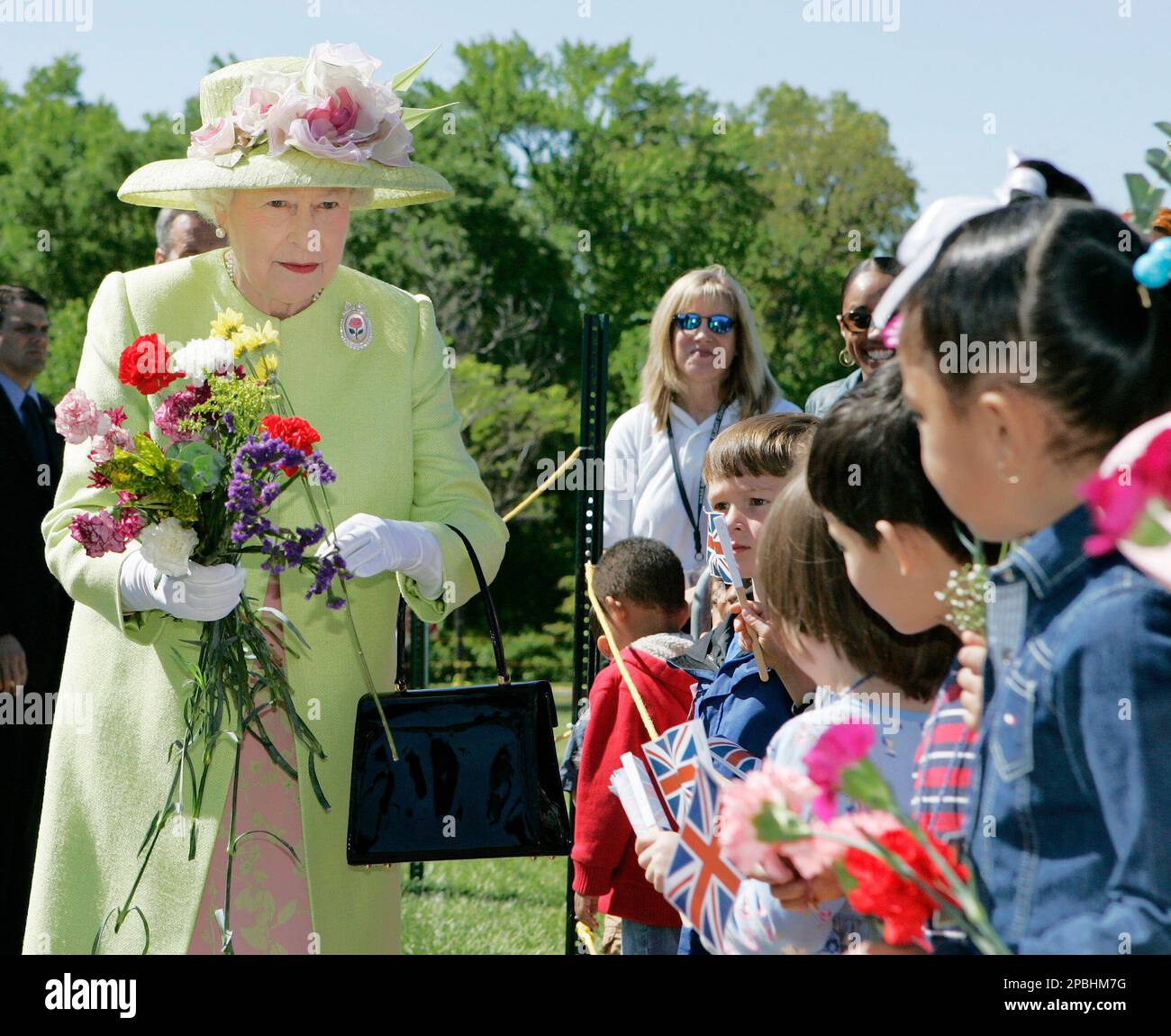 Britain's Queen Elizabeth II accepts flowers from children during a ...