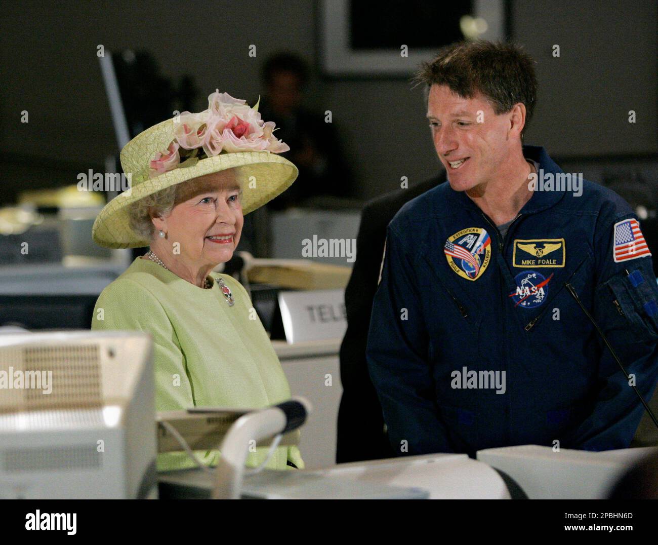 Queen Elizabeth II listens as NASA astronaut Mike Foale, right ...