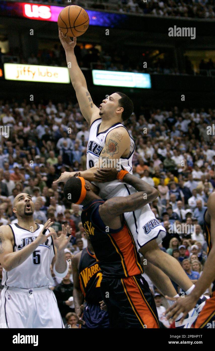 Utah Jazz's Deron Williams, top, scores over Golden State Warriors ...