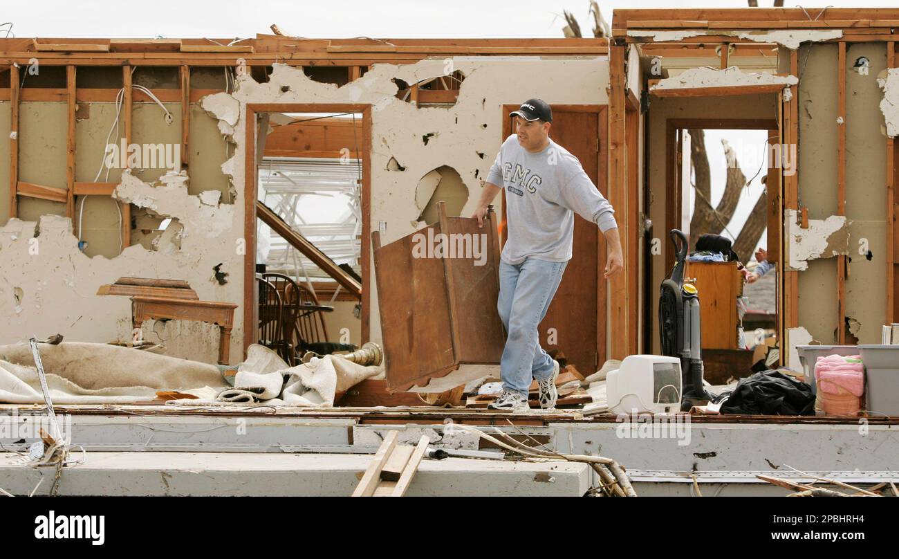 Brian Goodheart helps clean up his parents home in Greensburg, Kan ...