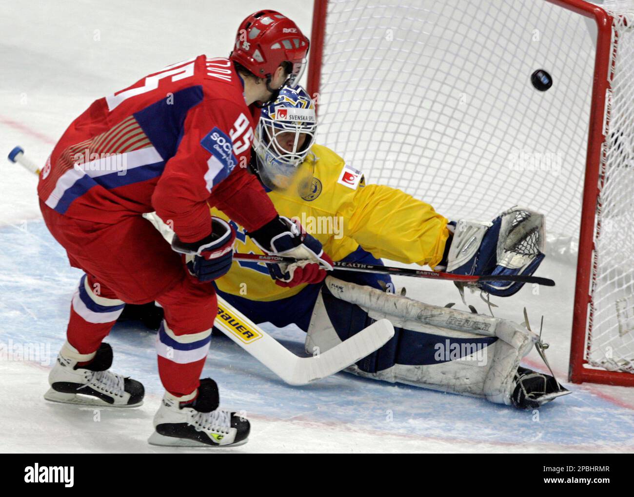 Russia's Alexey Morozov, left, scores a penalty shot against Sweden's ...