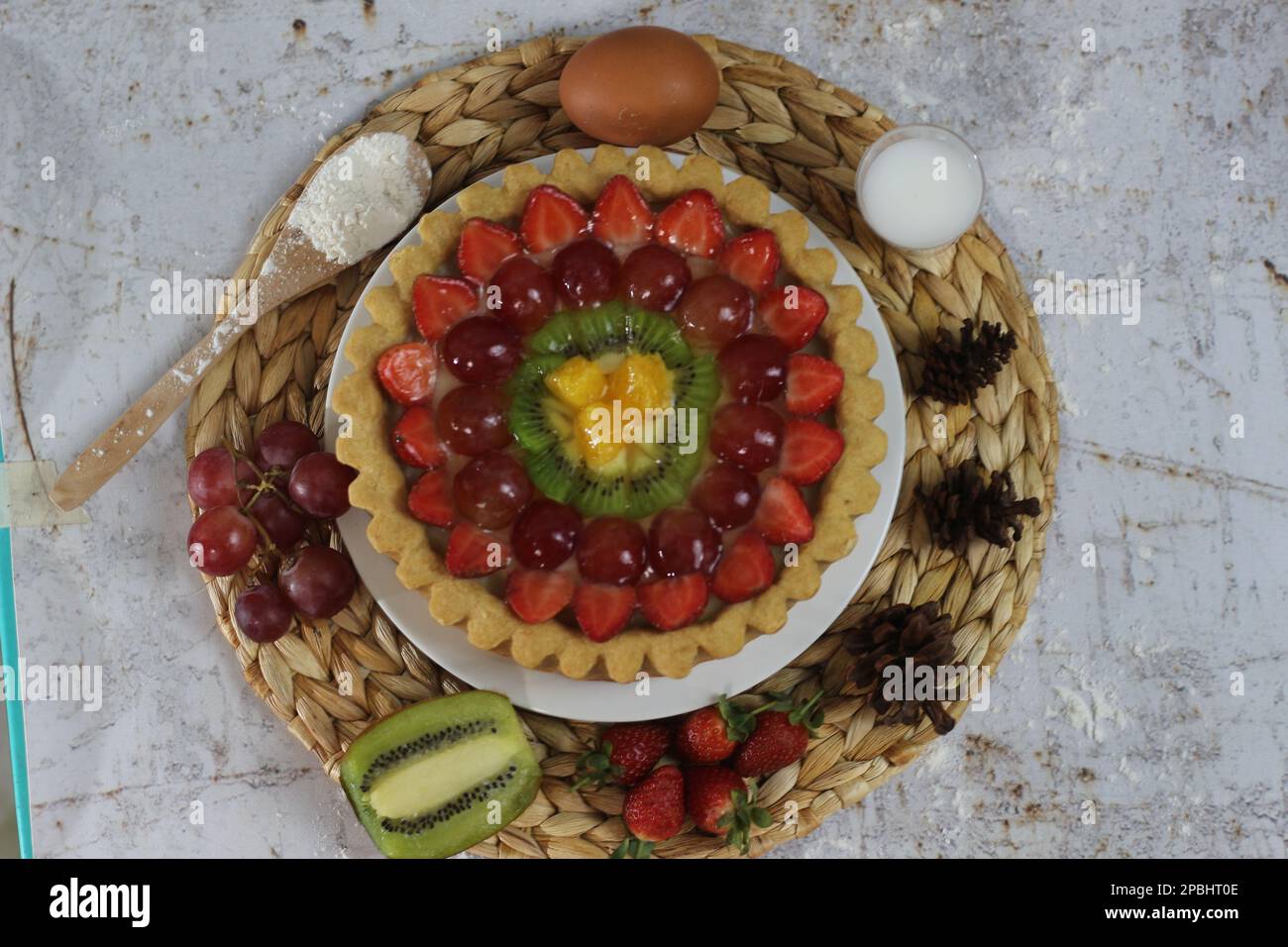big fruit pie with toppings of strawberries, grapes, kiwi and pineapple ...