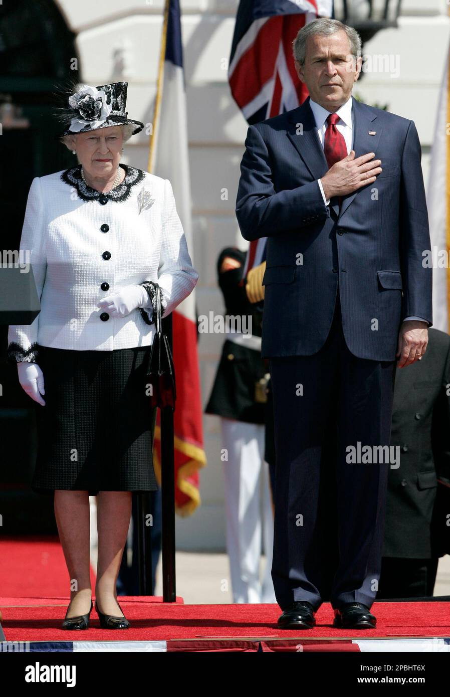 Queen Elizabeth II and President Bush stand at attention during an ...