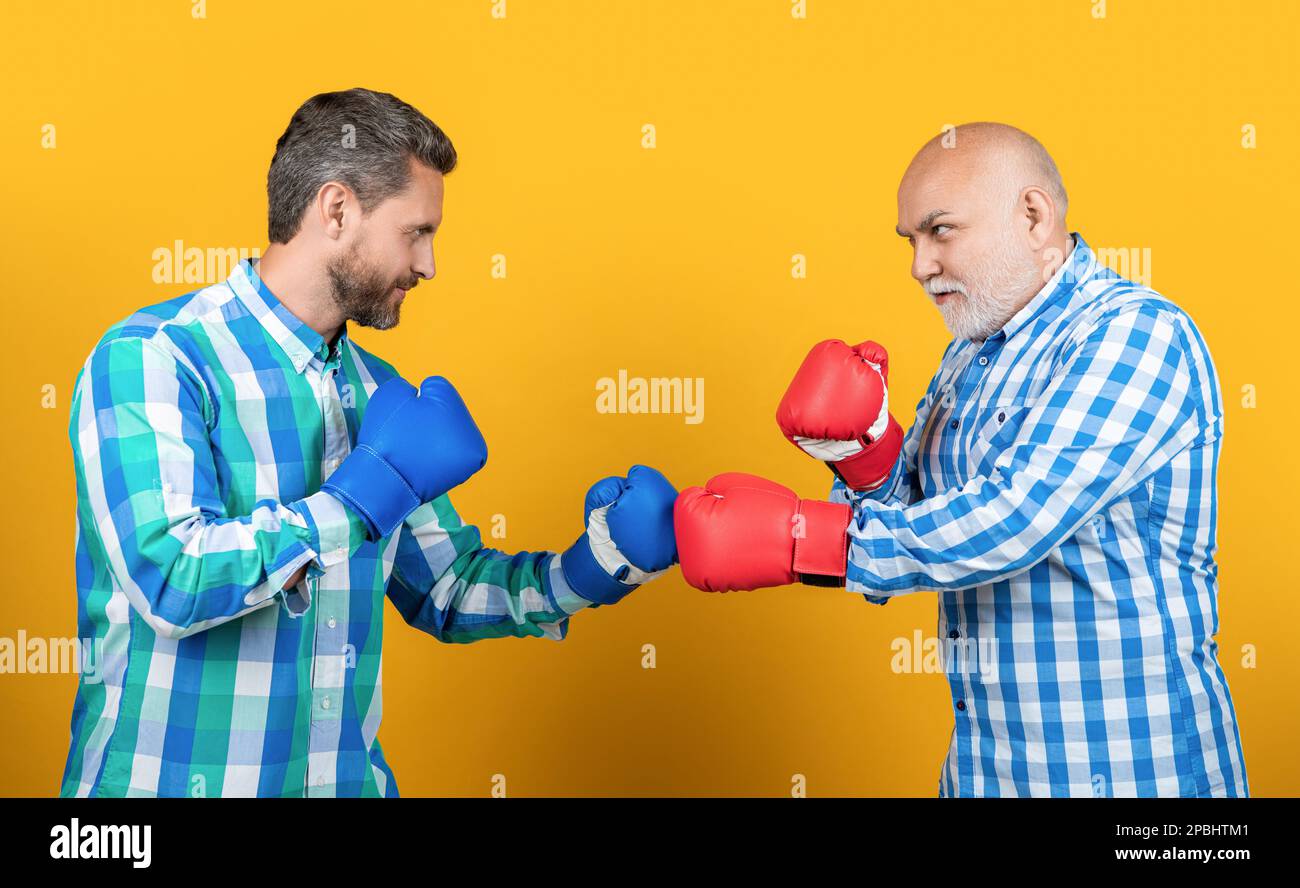 two generation men boxing isolated on yellow. generation men boxing in ...
