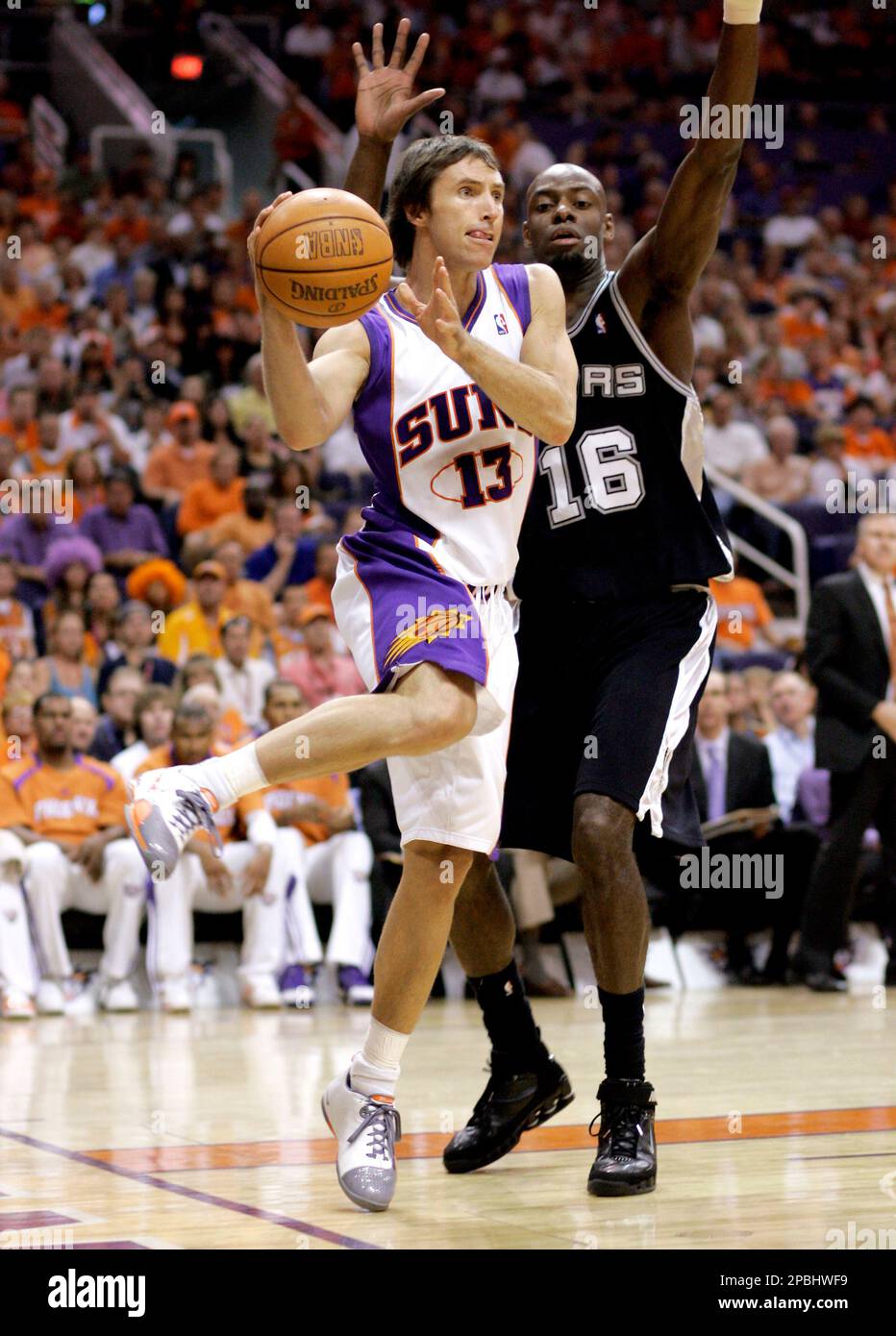 Phoenix Suns guard Steve Nash (13) passes around San Antonio Spurs ...