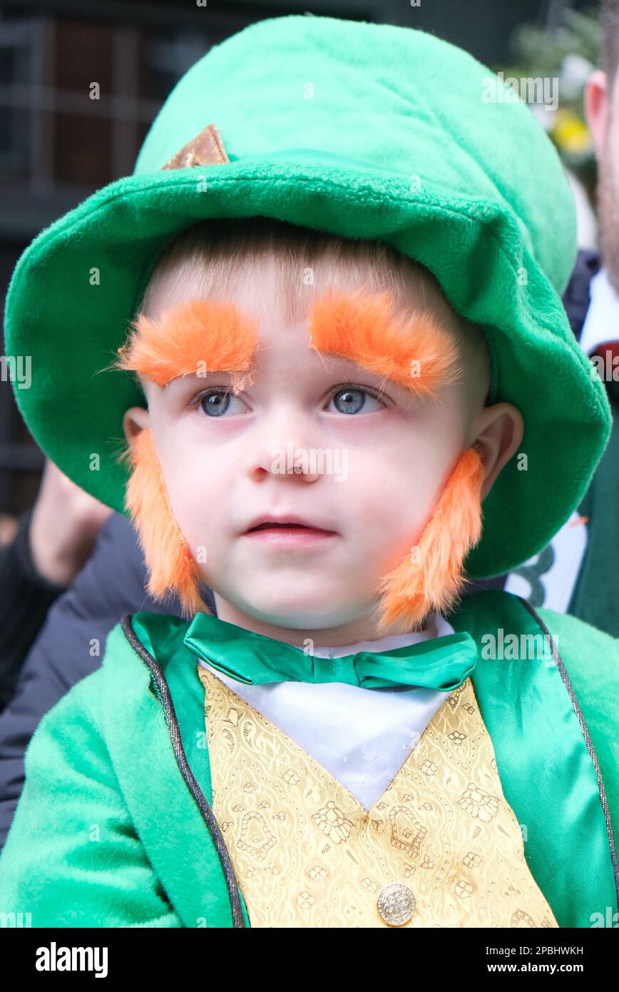 London, UK. 12th March, 2023. A child dressed as a leprechaun waits for ...