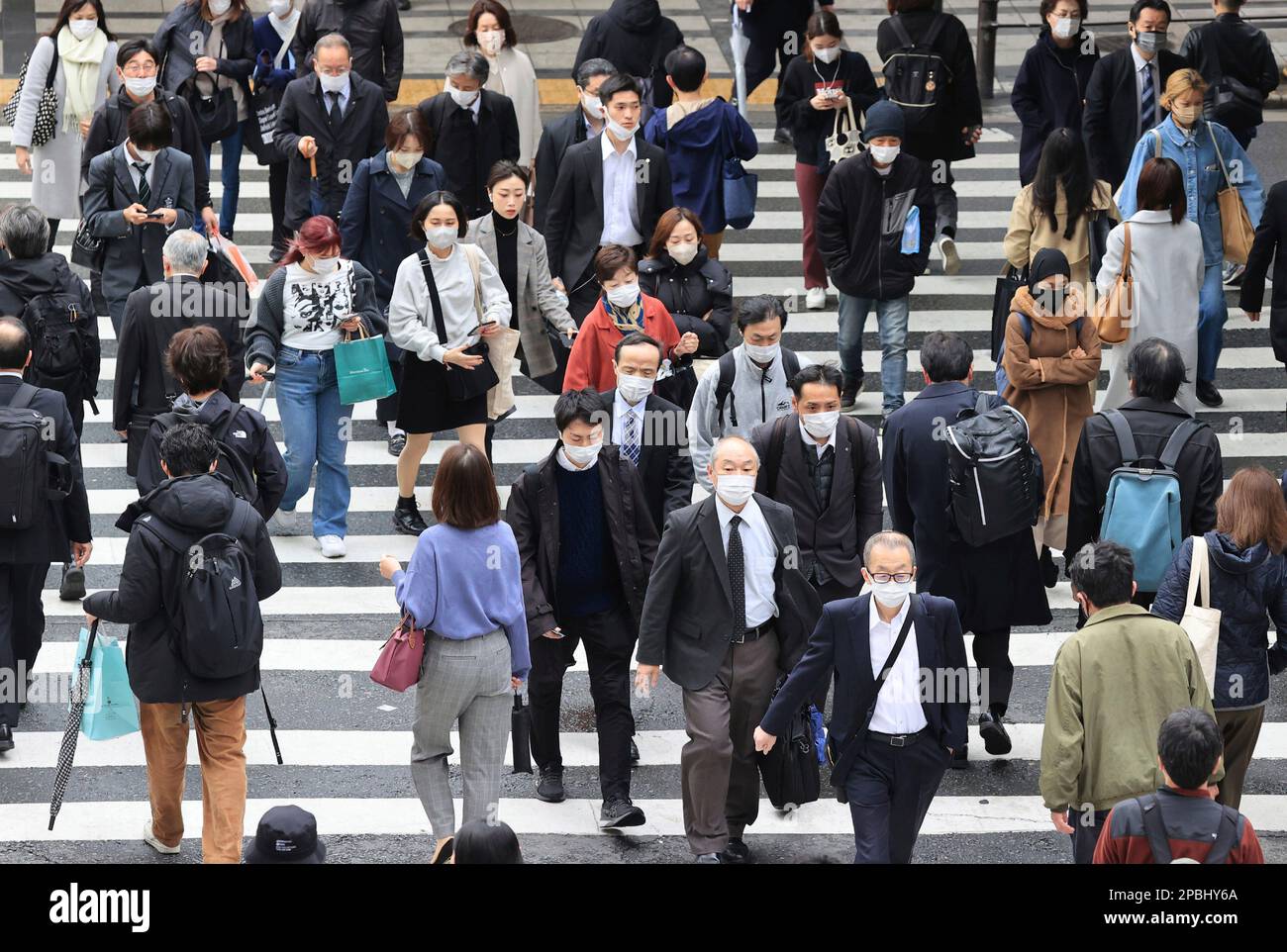 Many commuters still wear masks near Osaka Station in Osaka on March 13 ...