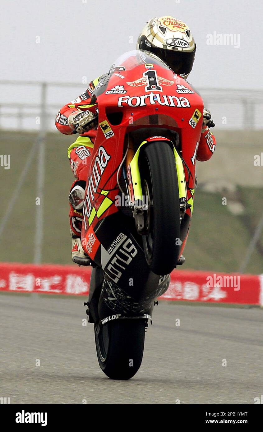 Spanish 250cc rider Jorge Lorenzo makes a whelie just before crossing ...