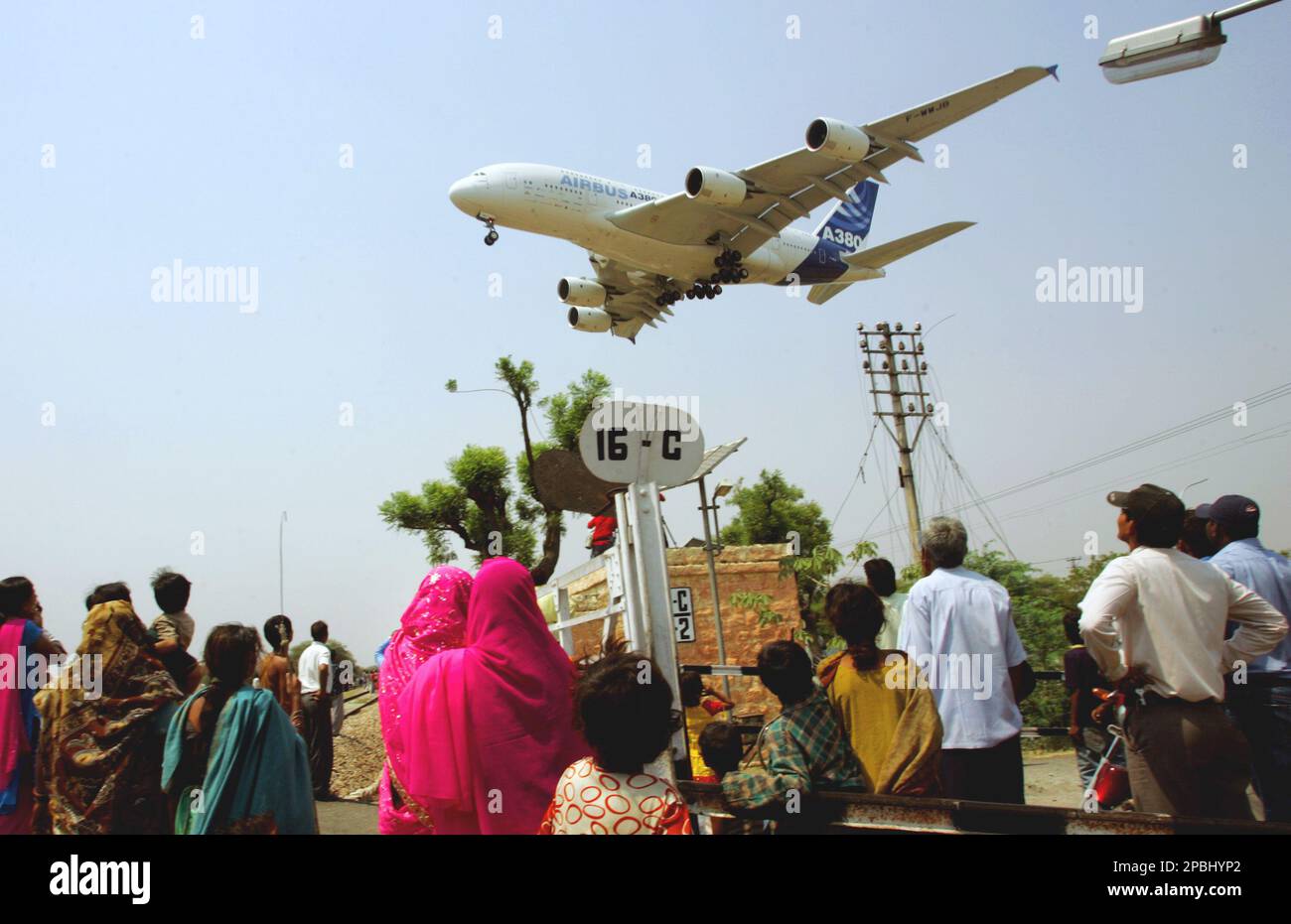 People look on as an Airbus A380 prepares to land at the Indira Gandhi ...