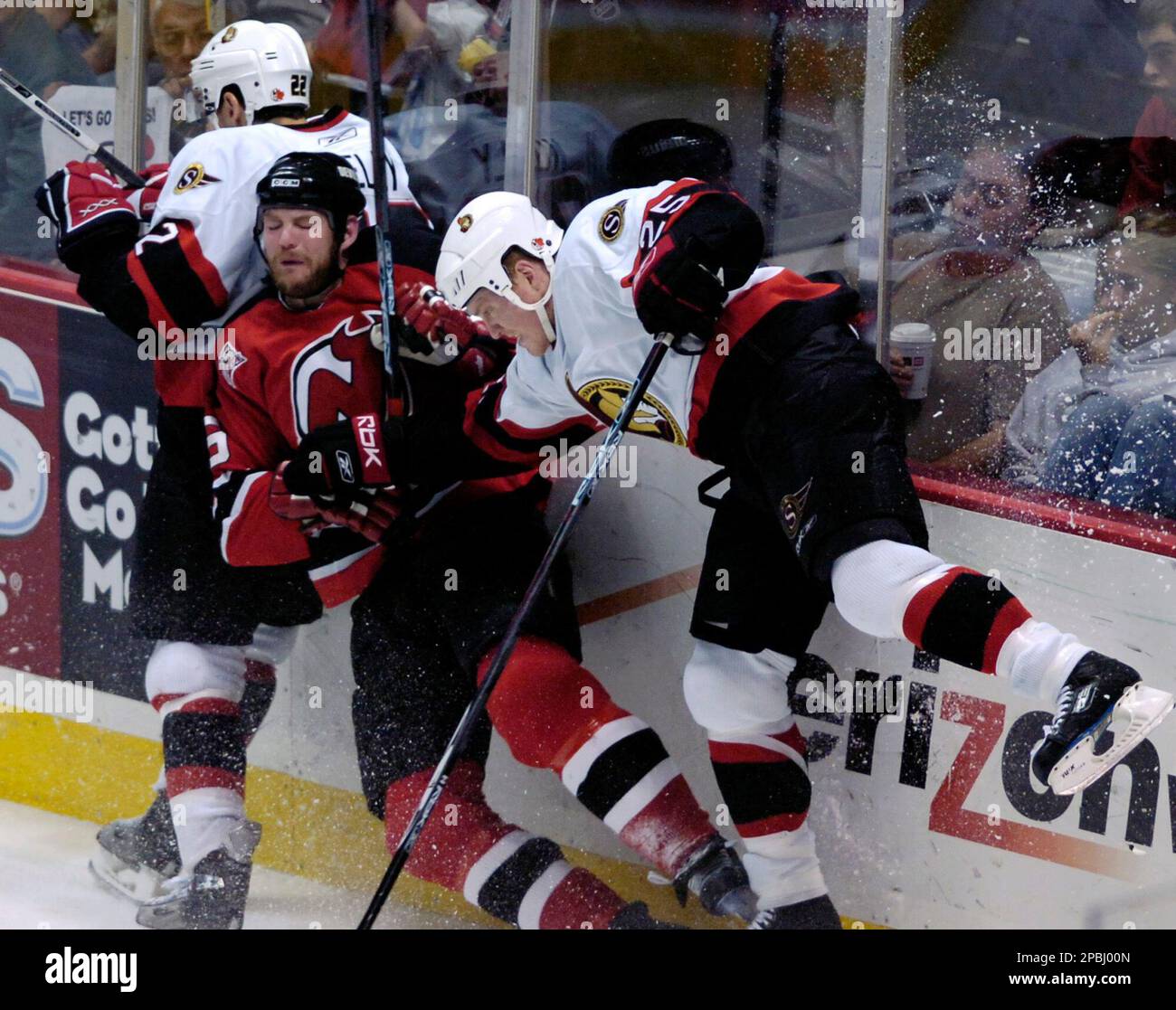 New Jersey Devils' Colin White gets sandwiched between Ottawa Senators ...