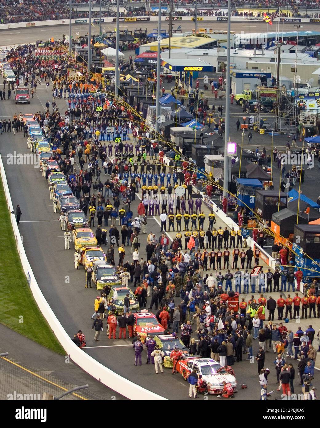 Teams line on on pit row for the national anthem before NASCAR Crown ...