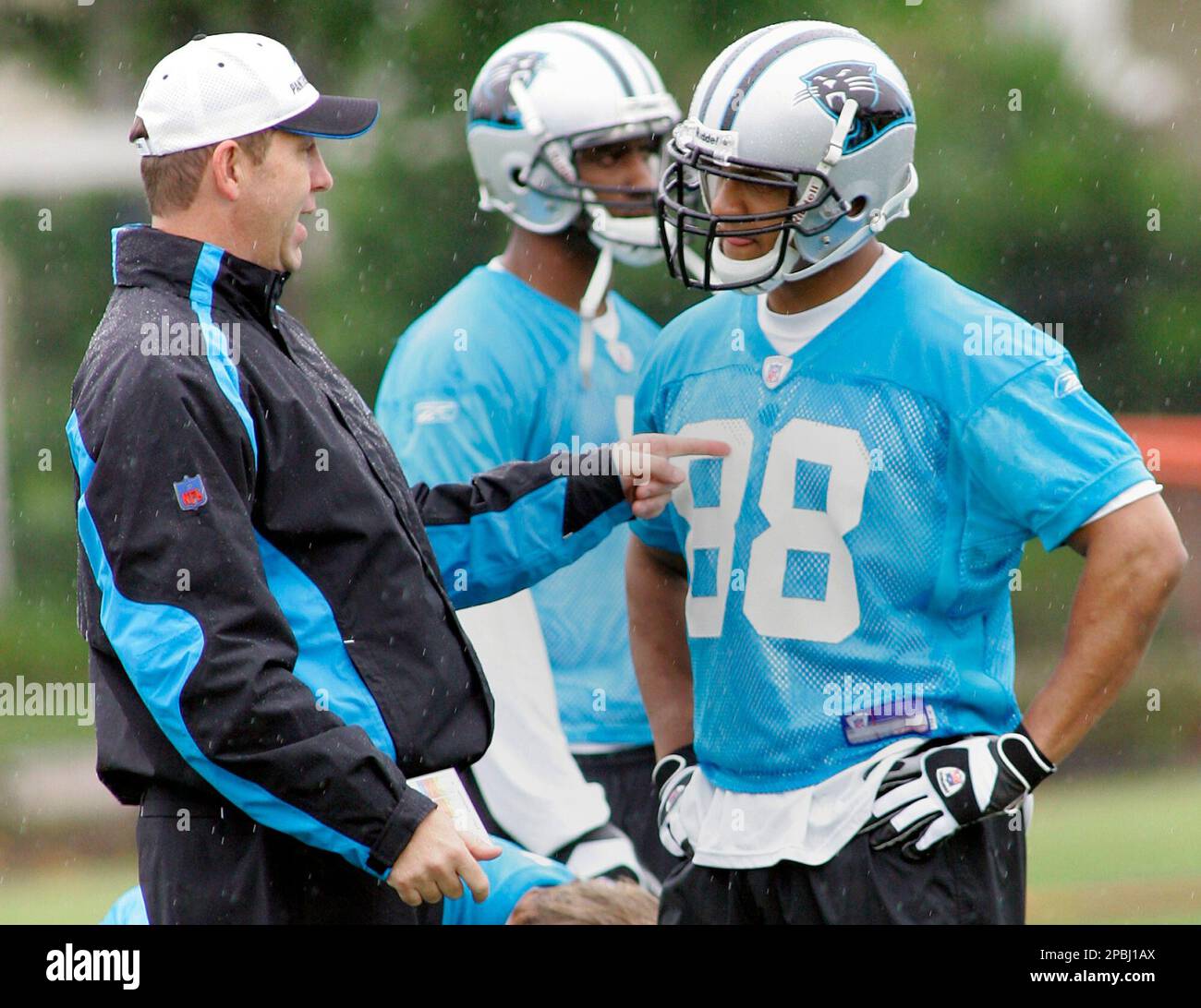 Carolina Panthers receiver Dante Rosario, right, gets some pointers ...