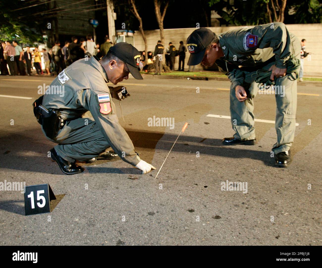 Thai police forensic investigate near the site of the blast in Bangkok ...