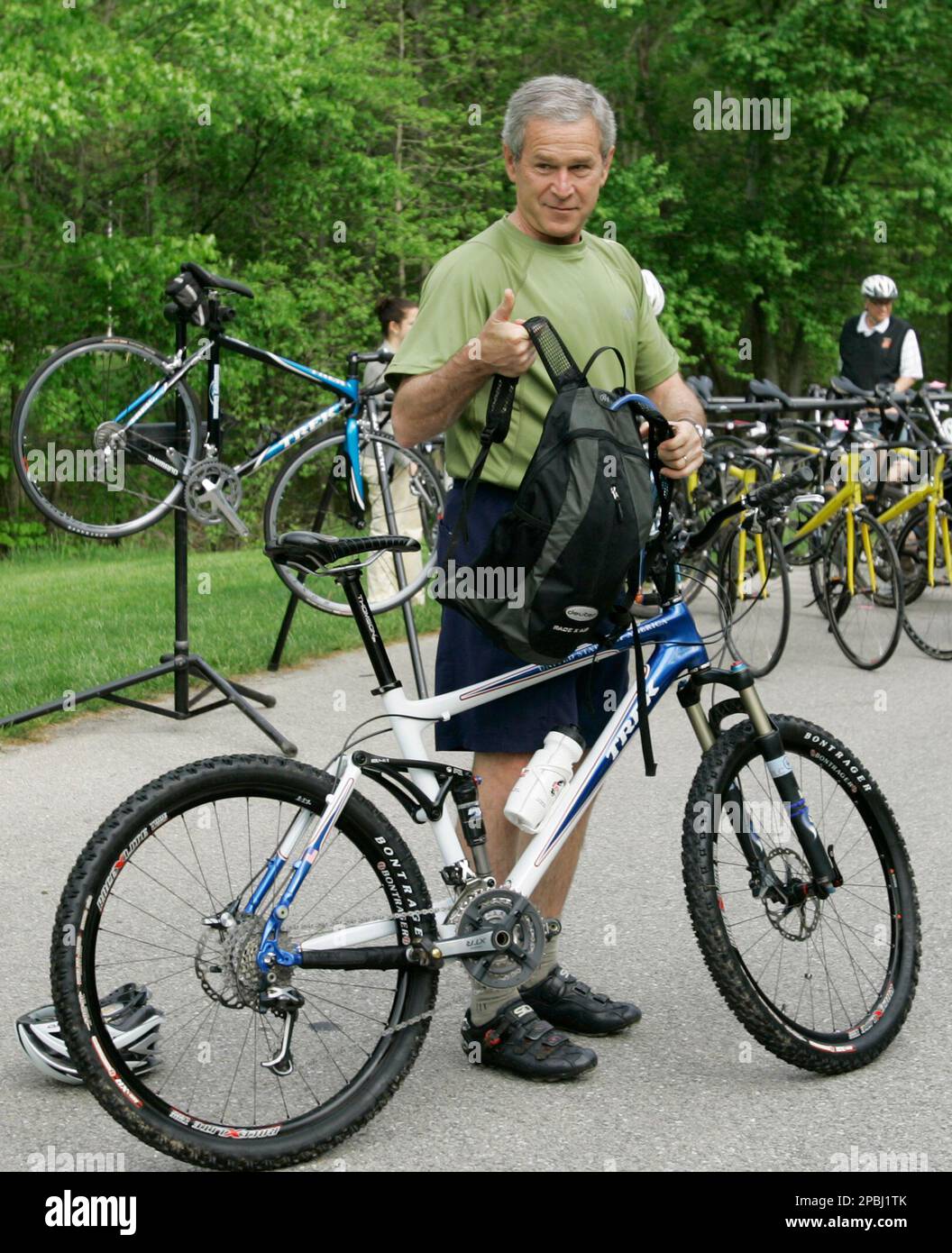 President Bush flashes a thumbs up as he gears up for a mountain bike ...