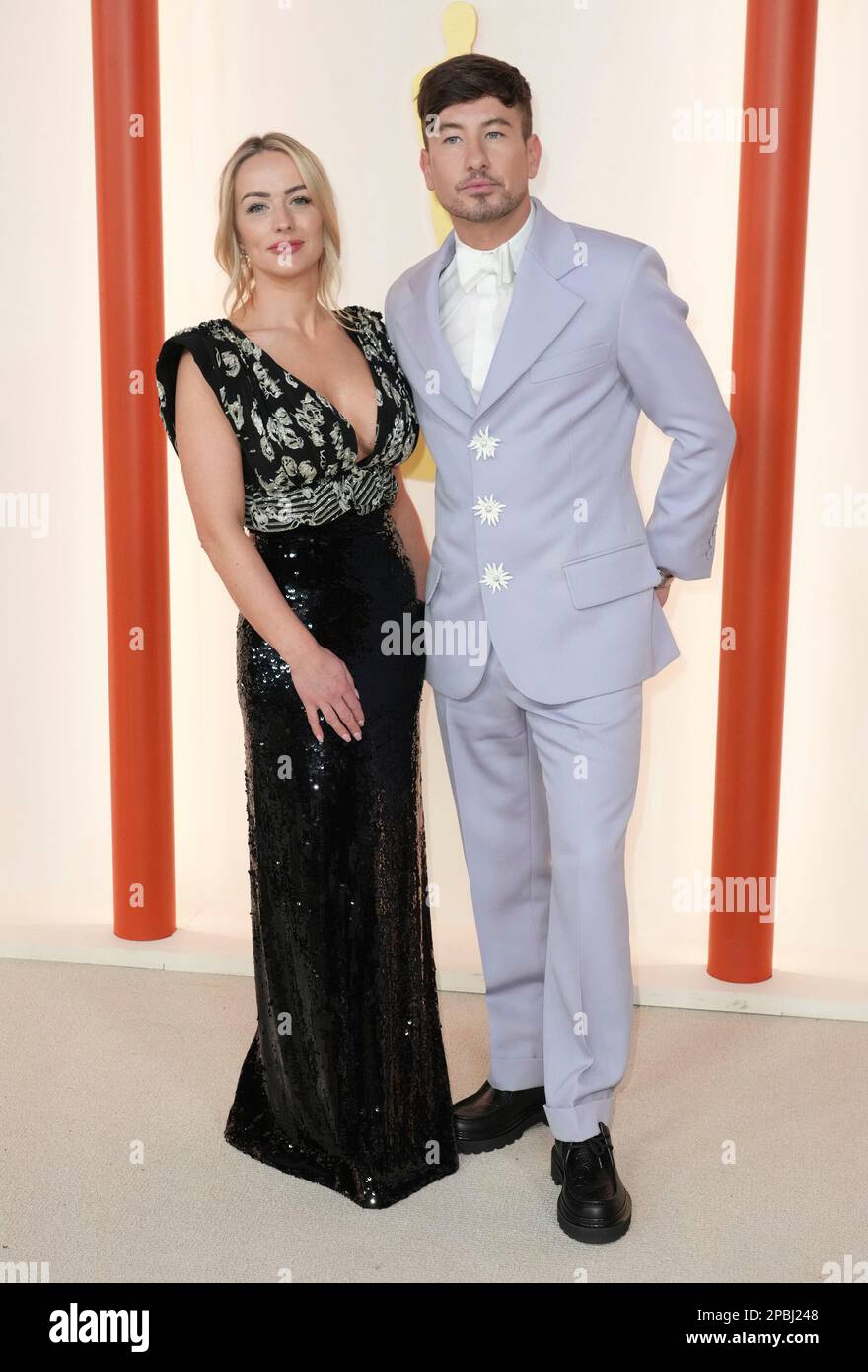 Alyson Sandro, left, and Barry Keoghan arrive at the Oscars on Sunday ...